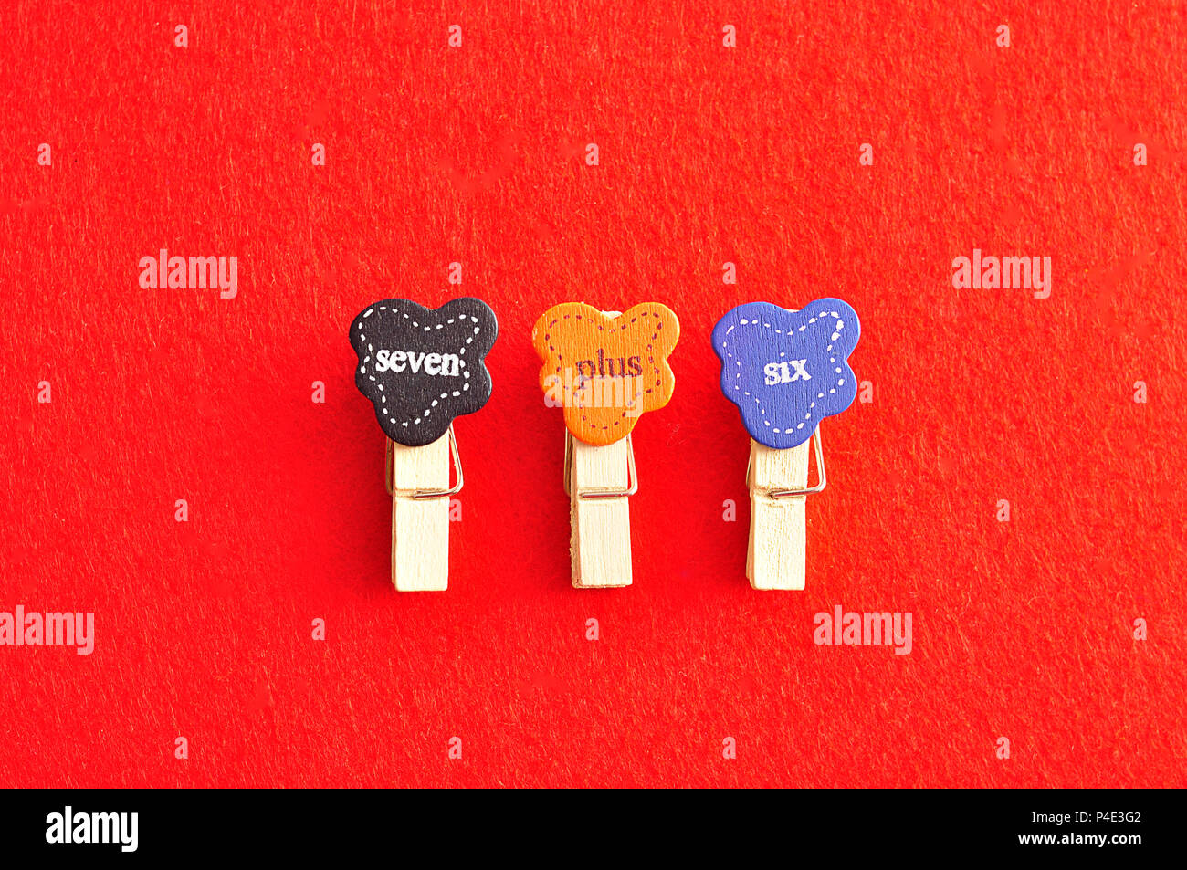 Seven plus six on a red background Stock Photo - Alamy