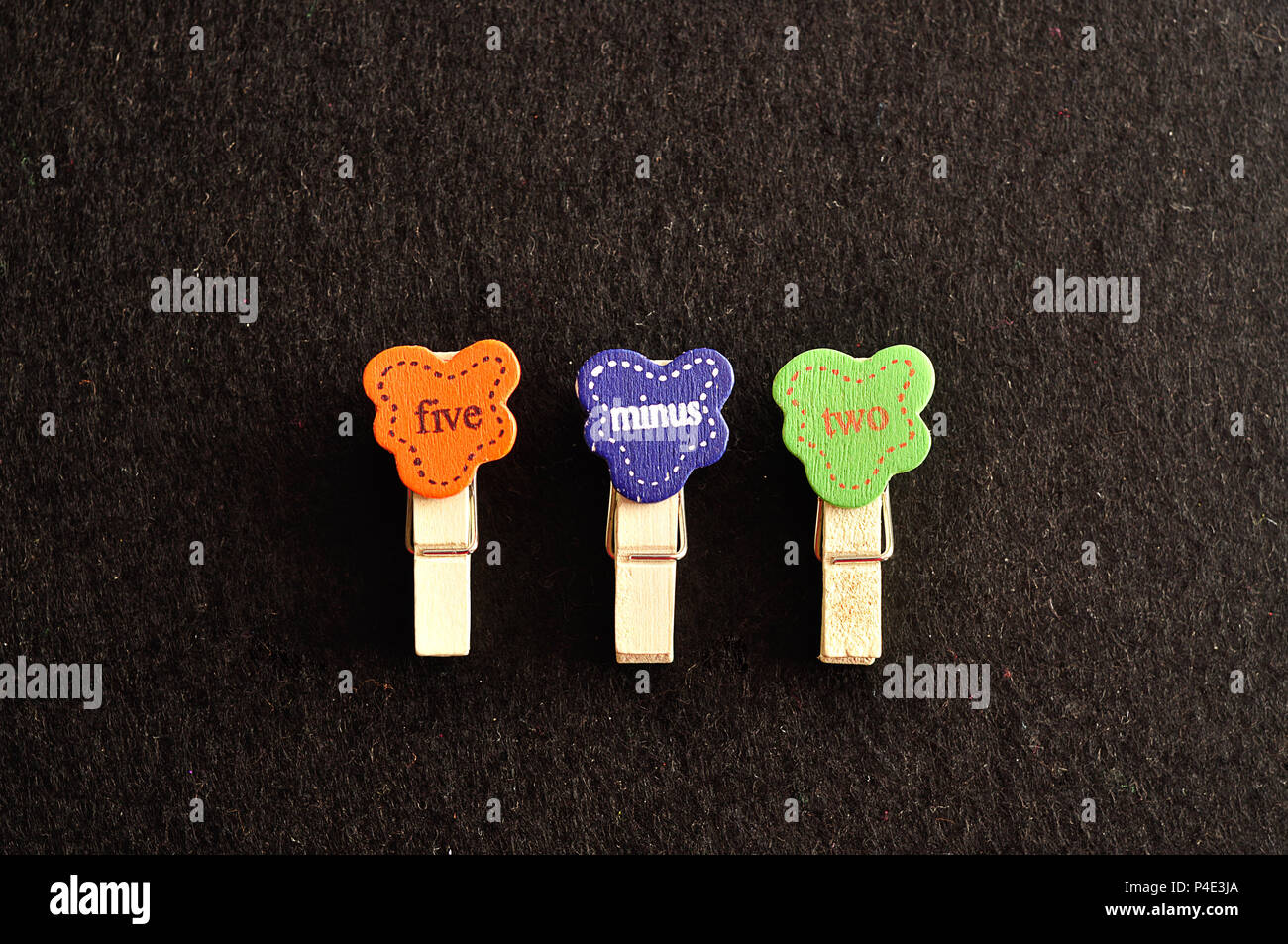 Five minus two on a black background Stock Photo - Alamy