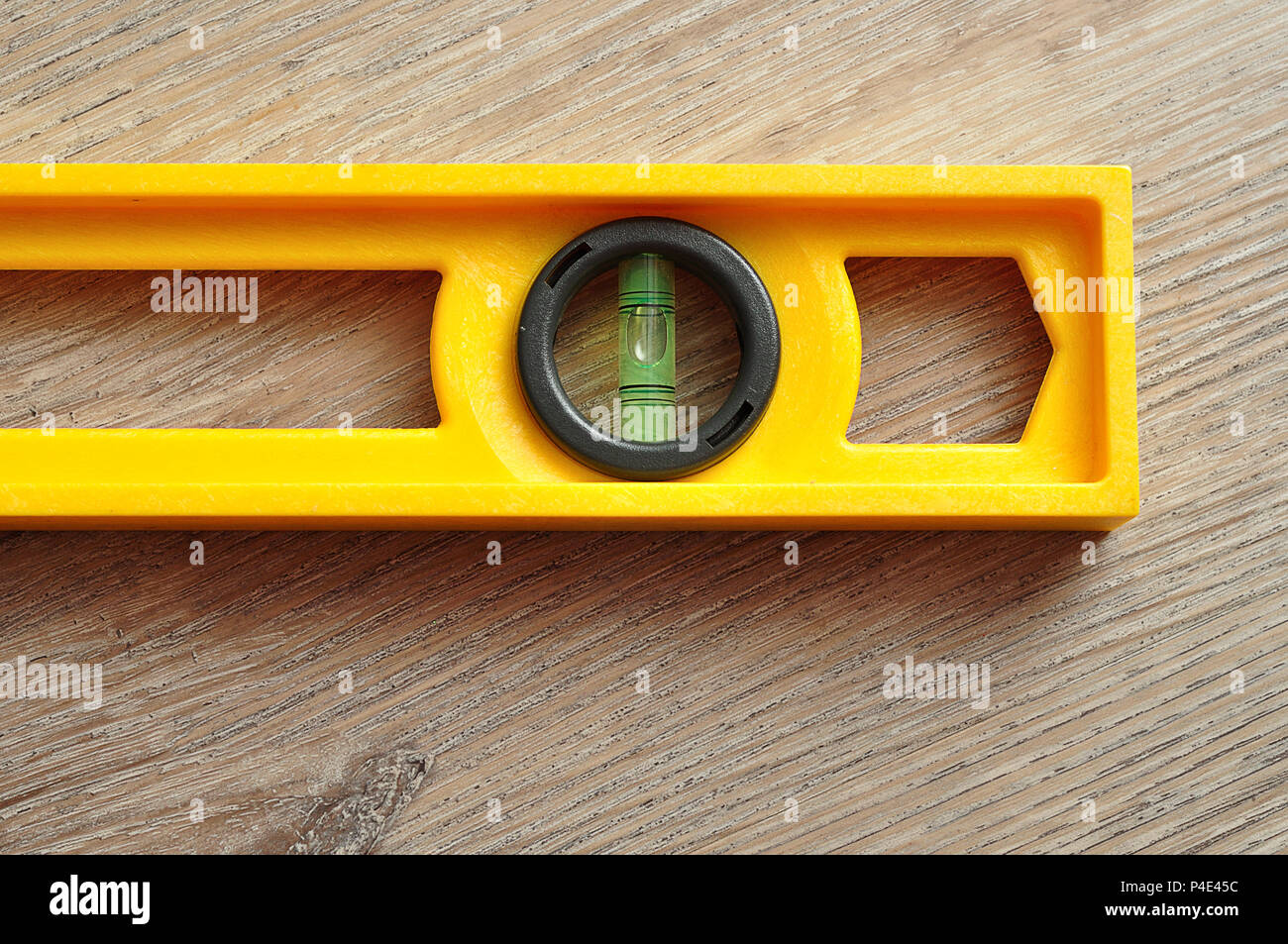 A level isolated on a wooden background Stock Photo - Alamy
