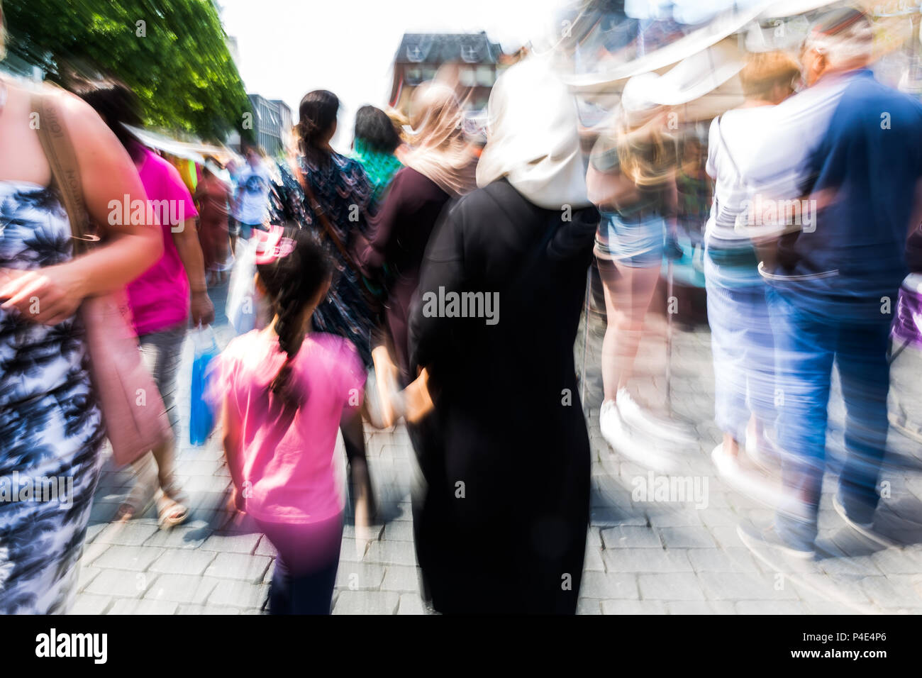 abstract picture with camera made zoom effect of people walking in the ...