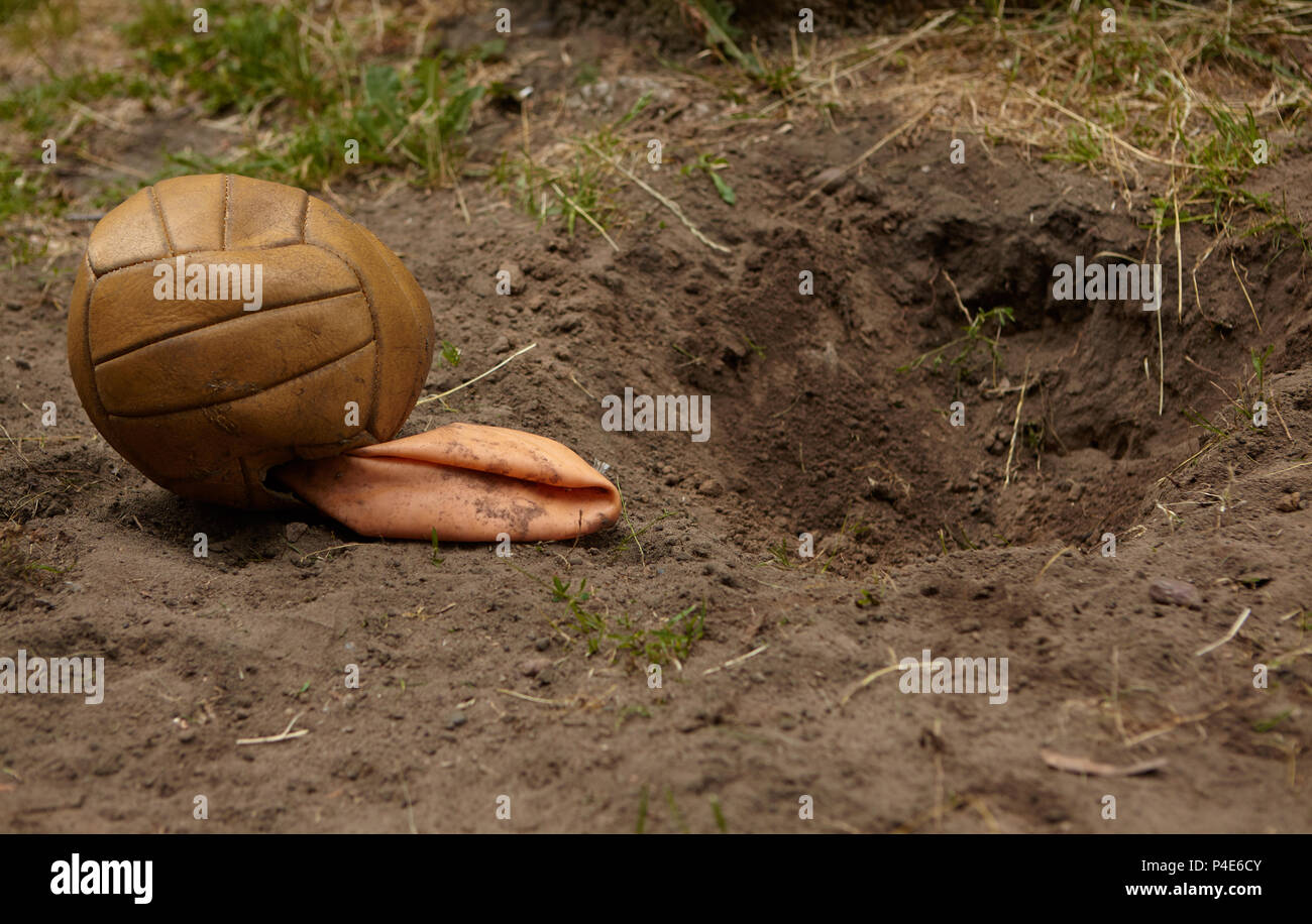Broken football, ball. Bitten ball by a dog Stock Photo - Alamy