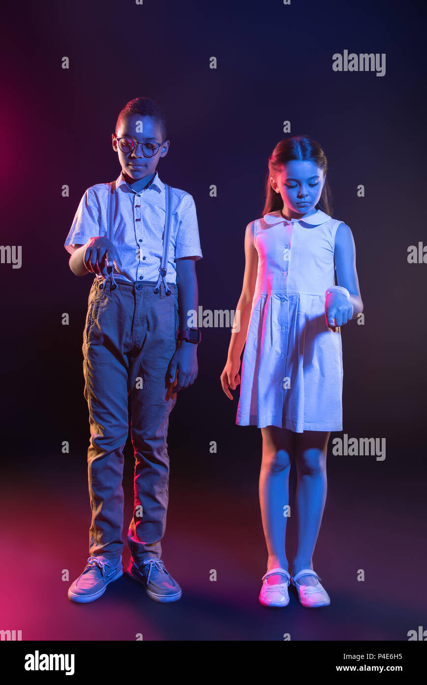 Concentrated kids pressing imaginary buttons Stock Photo - Alamy