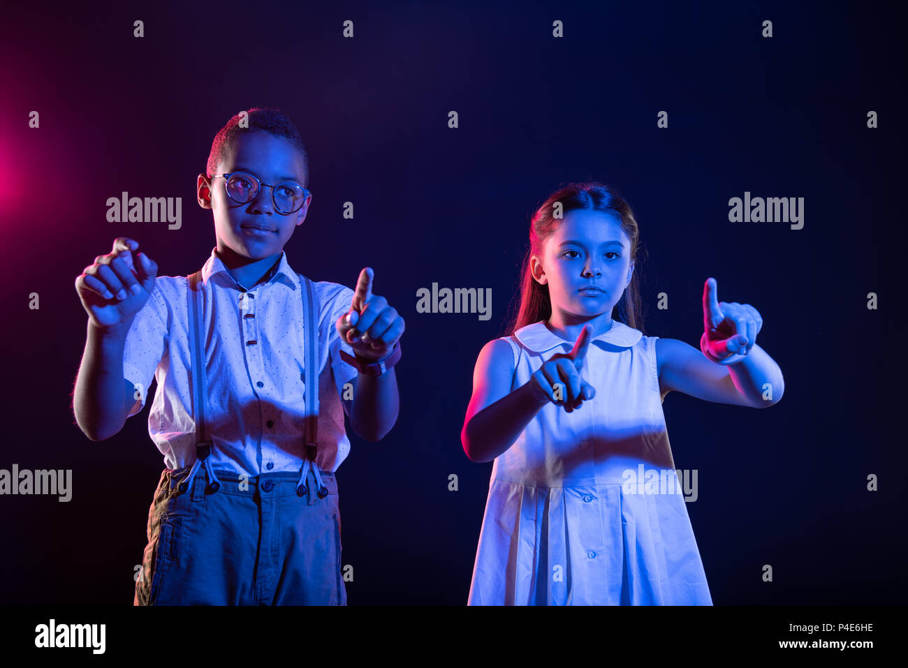 Serious kids pressing imaginary buttons Stock Photo - Alamy