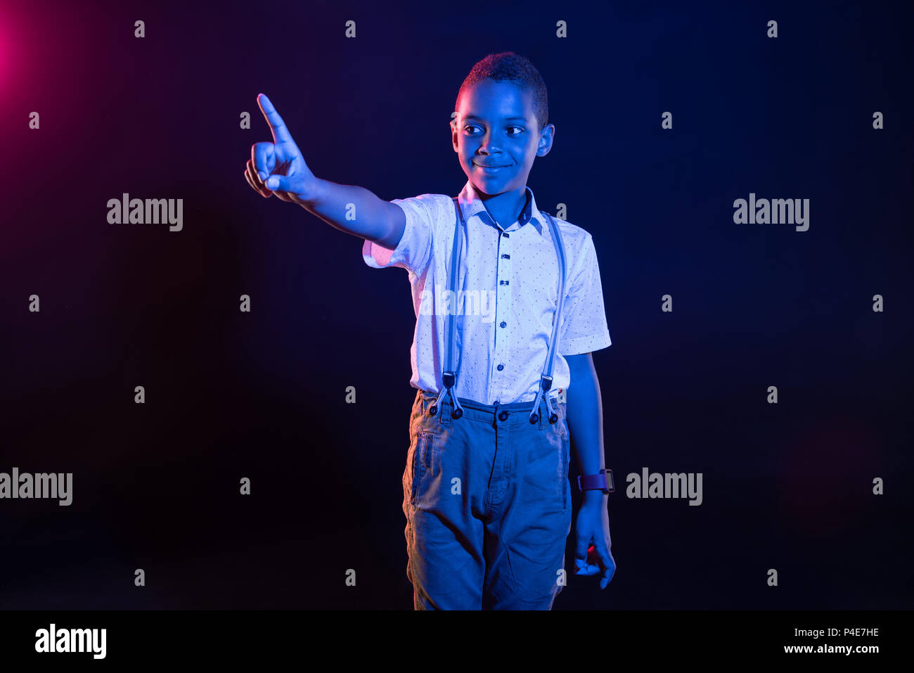 Happy little boy pressing imaginary buttons Stock Photo - Alamy