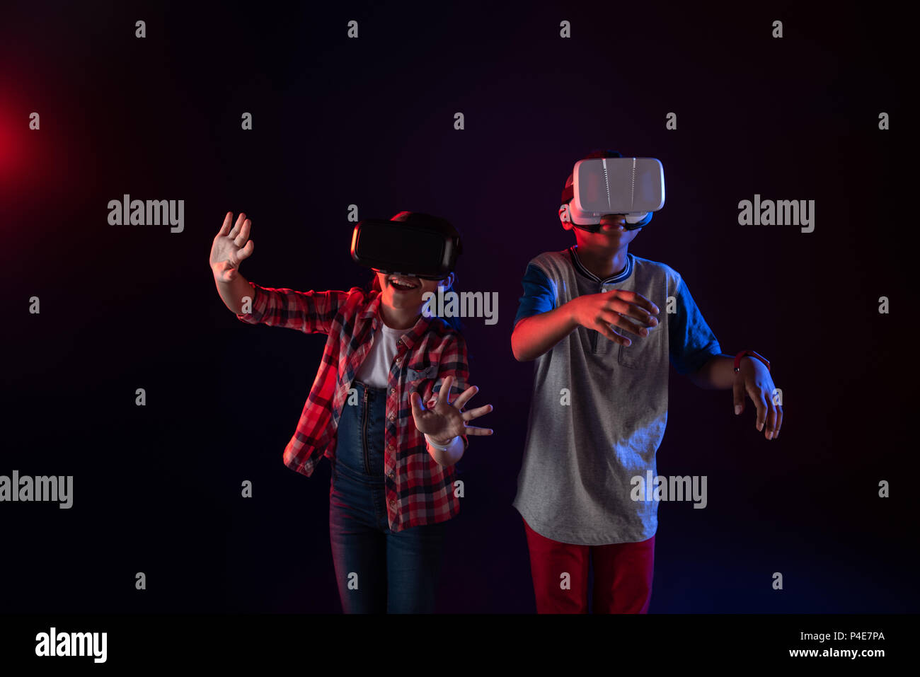 Exuberant kids wearing VR headsets Stock Photo - Alamy