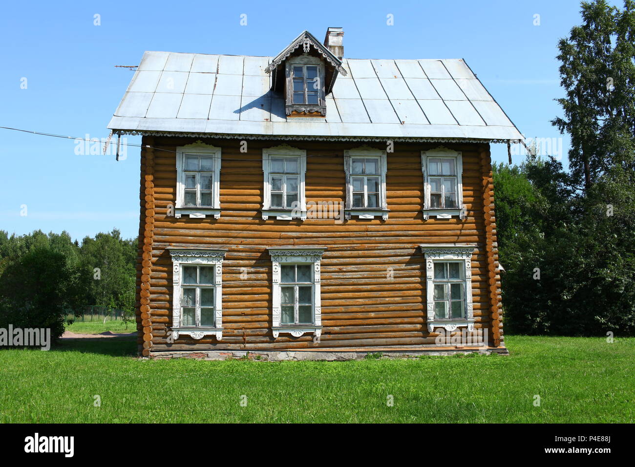 View of the old a log house with an attic Stock Photo - Alamy