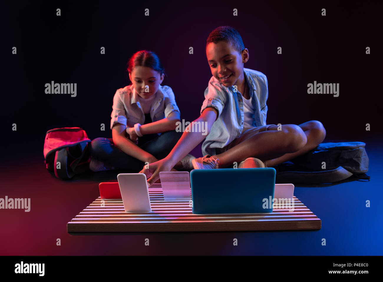 Children playing gadgets hi-res stock photography and images - Alamy