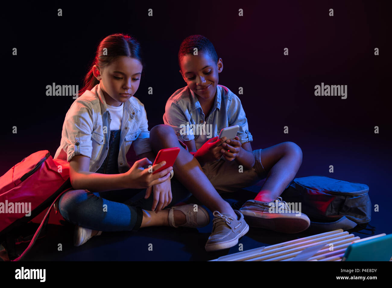 Inspired children playing with their gadgets Stock Photo - Alamy
