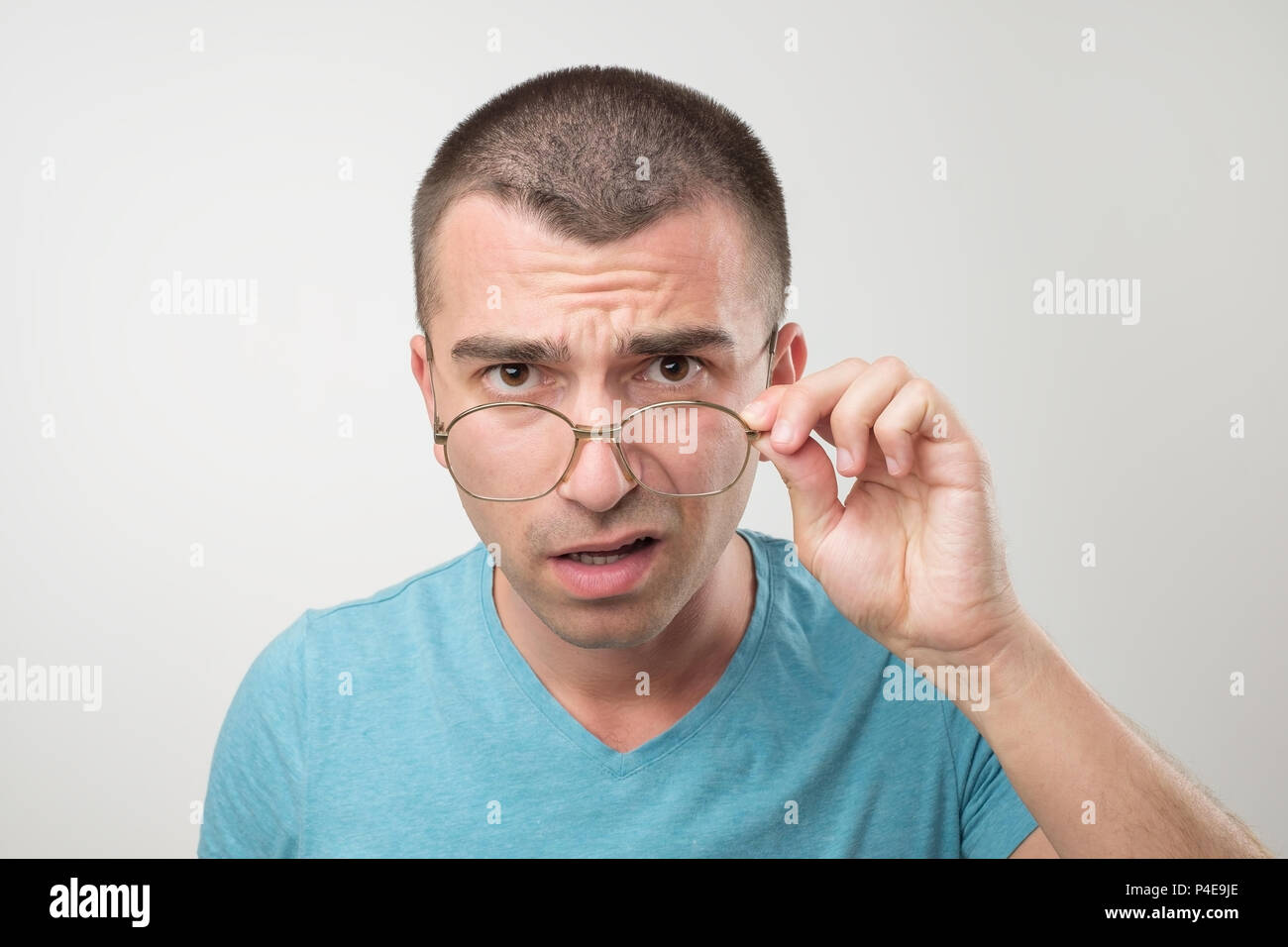 Wow facial emotion concept. Surprised young man with opened mouth ...