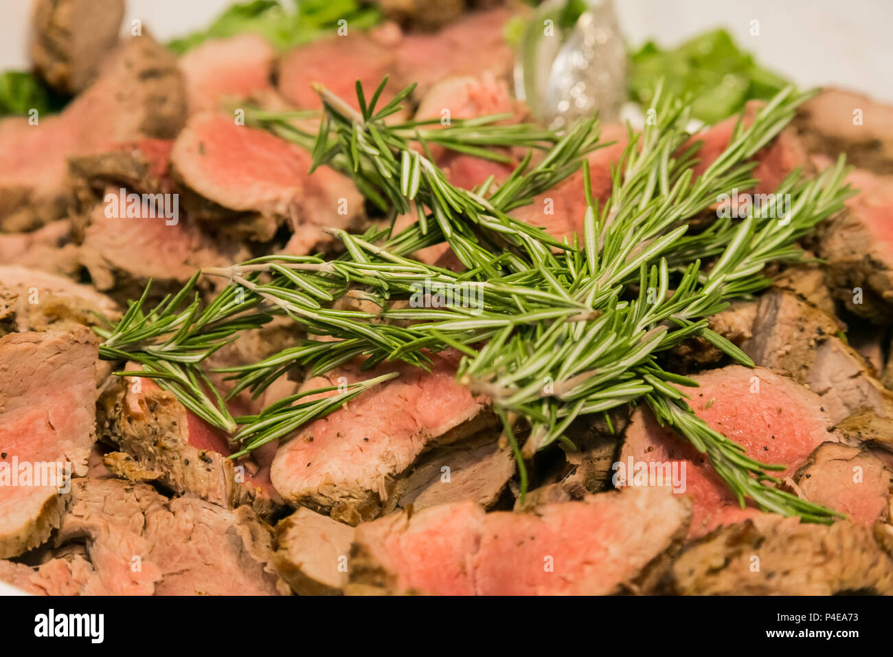 Large bowl of freshly roasted slices or prime beef for catering at a ...