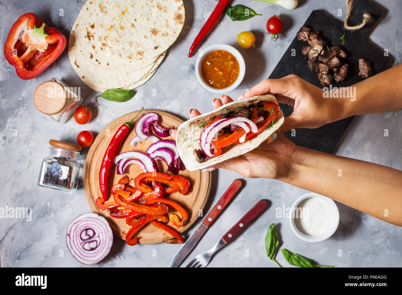 Female hands hold mexican tacos on concrete background. Cooking. Top ...