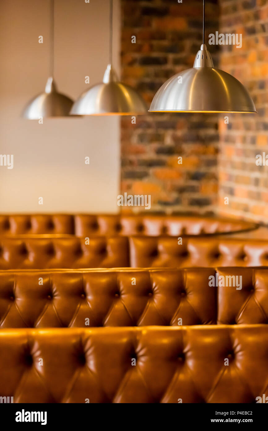 Lush Brown leather restaurant booths with hanging stainless steel ...