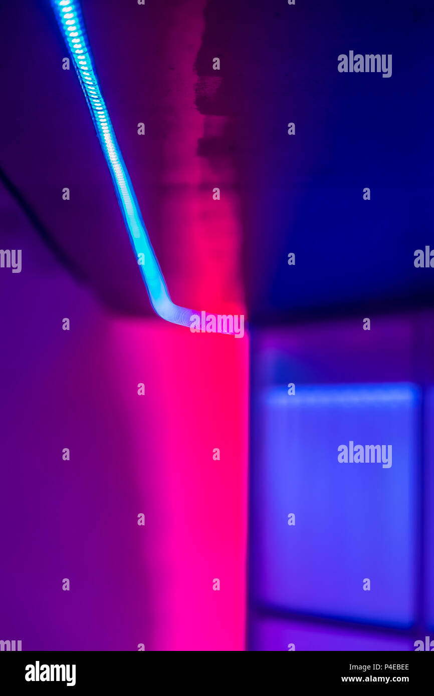 Pink and Purple stage lighting for display interior wall panels at an ...