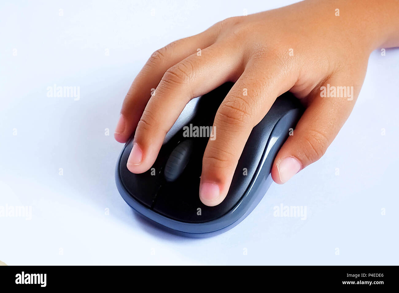Kid hand with modern computer mouse black color isolated on a white ...