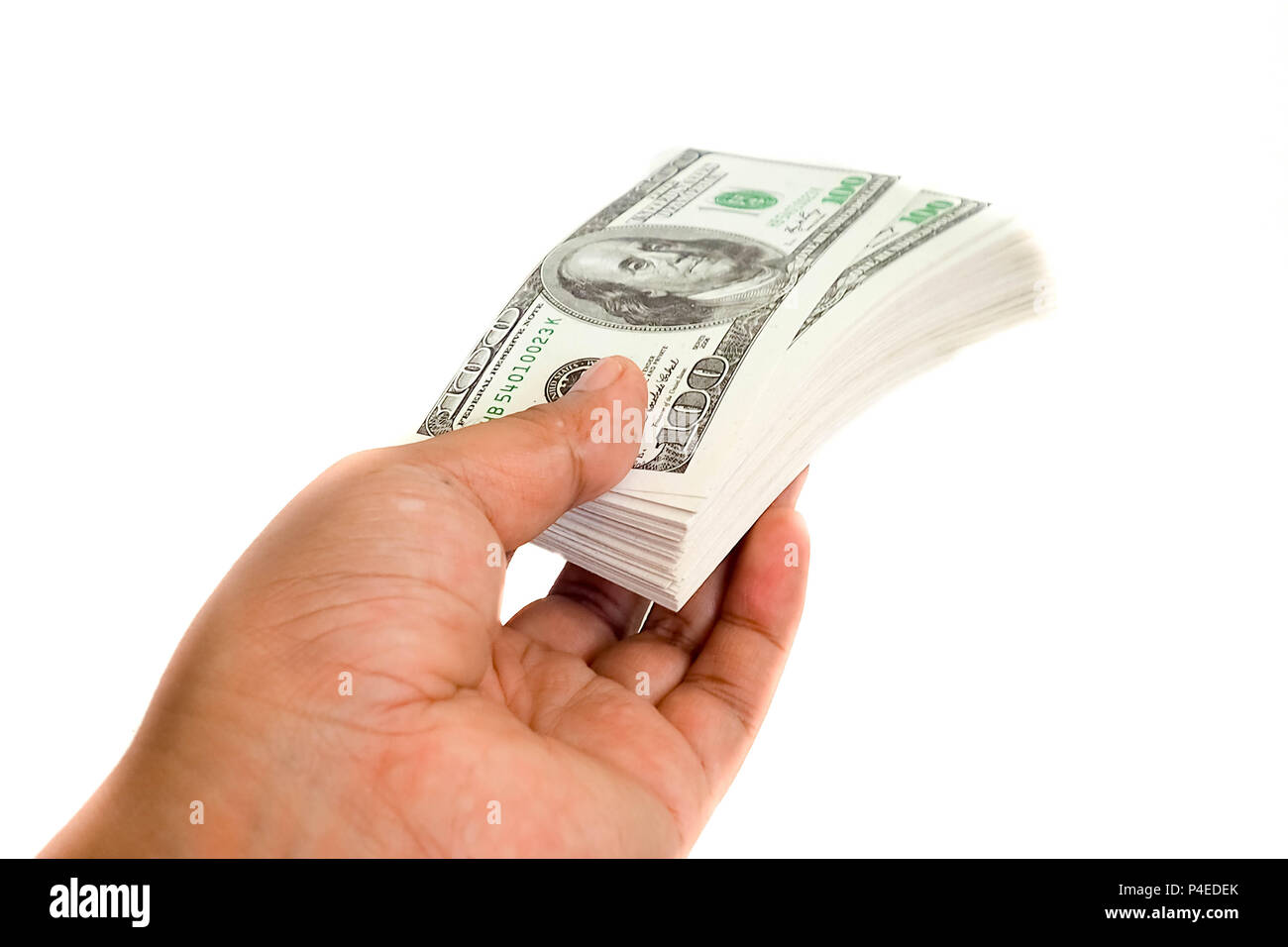 A hand handing over stack of one hundred dollar bills isolated on white ...
