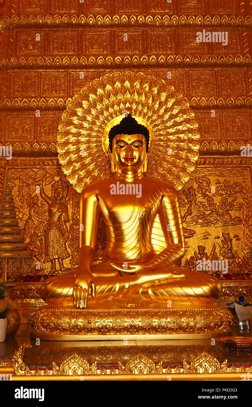 Buddha gold statue on golden background patterns in buddhism temple ...