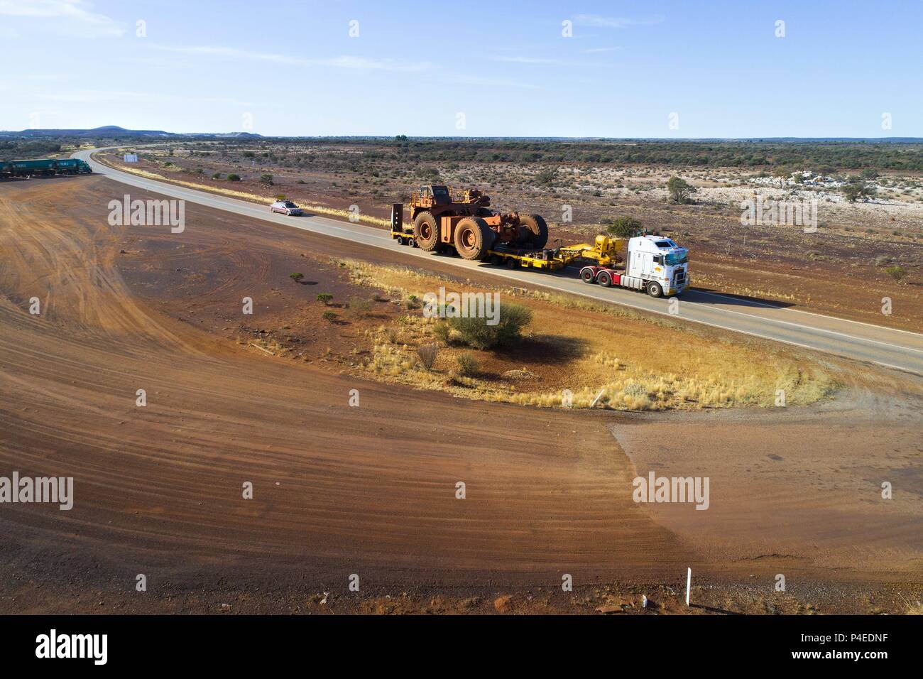 Aerial view of large dump truck without tray being transported by road ...