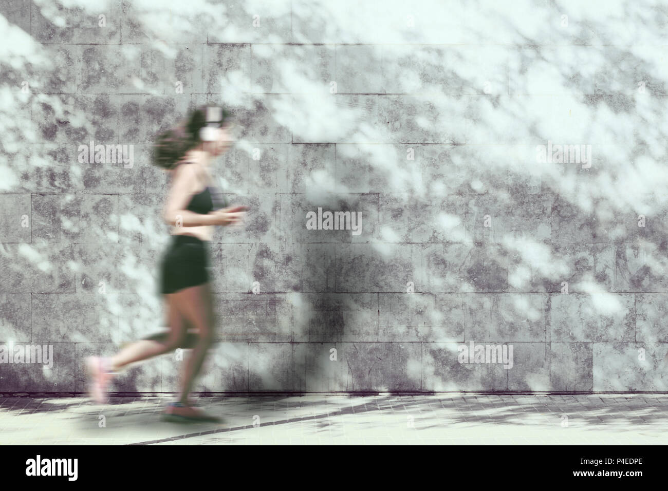 Young woman with ponytail running outdoors in summer. Empty copy space ...