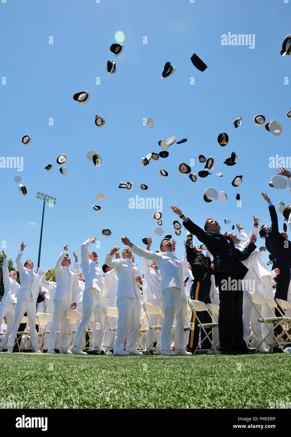 Midshipmen of the Class of 2018, throw their covers in the air after ...