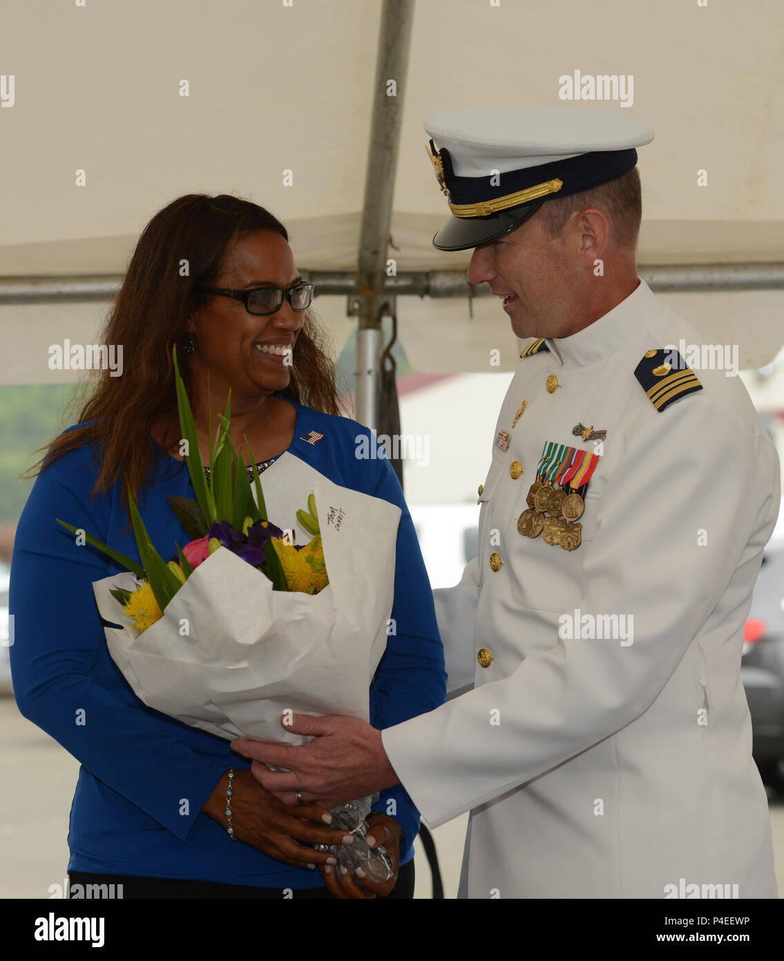 Lt. Cmdr. Thomas Condit gives a bouquet of flowers to his wife ...