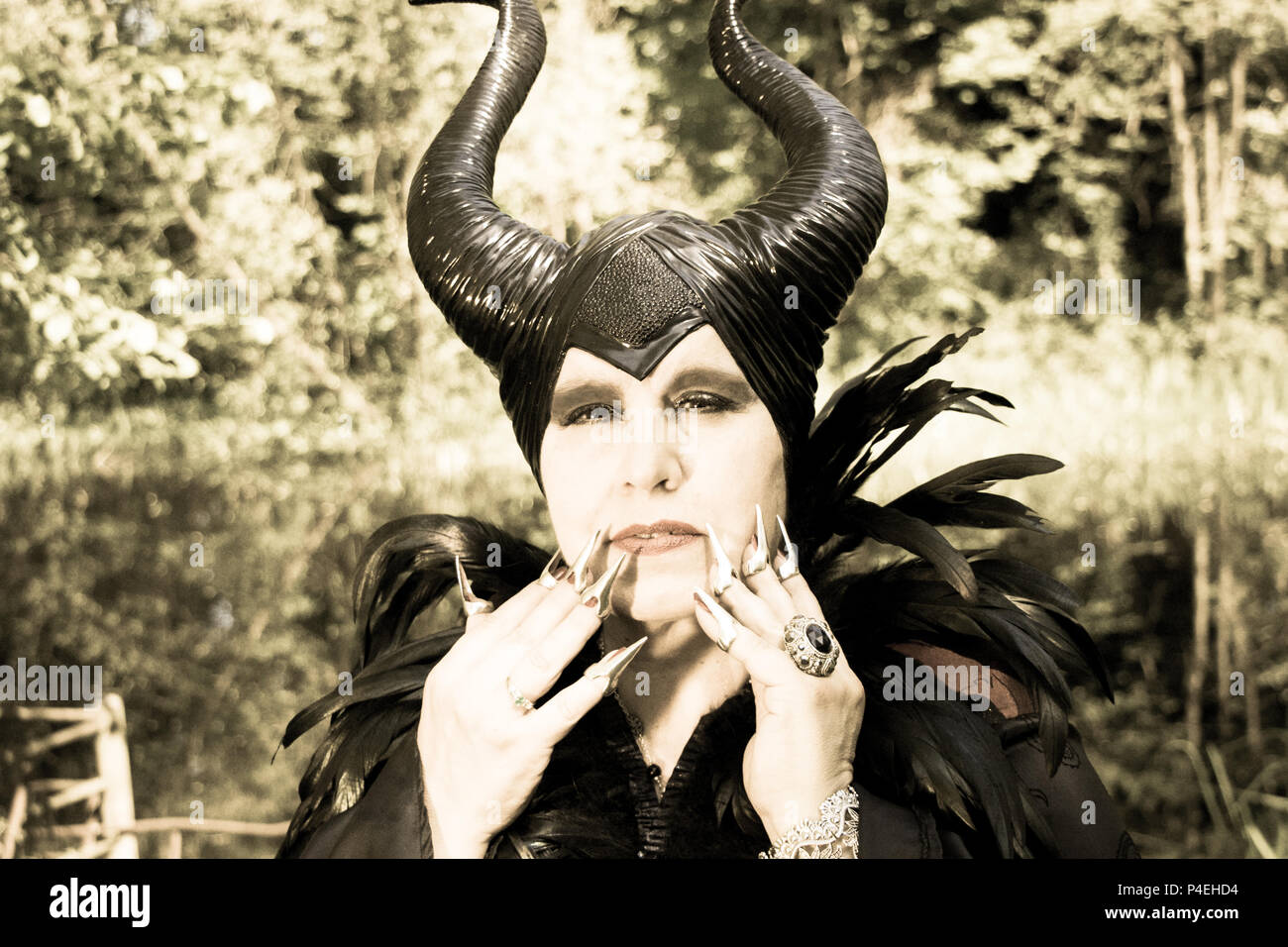 Evil fable queen with evil, malevolent and maleficent black horns, crow ...