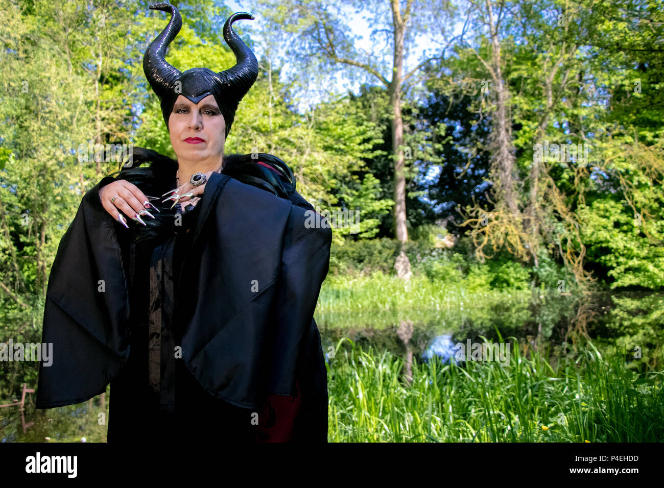 Evil fable queen with evil, malevolent and maleficent black horns, crow ...