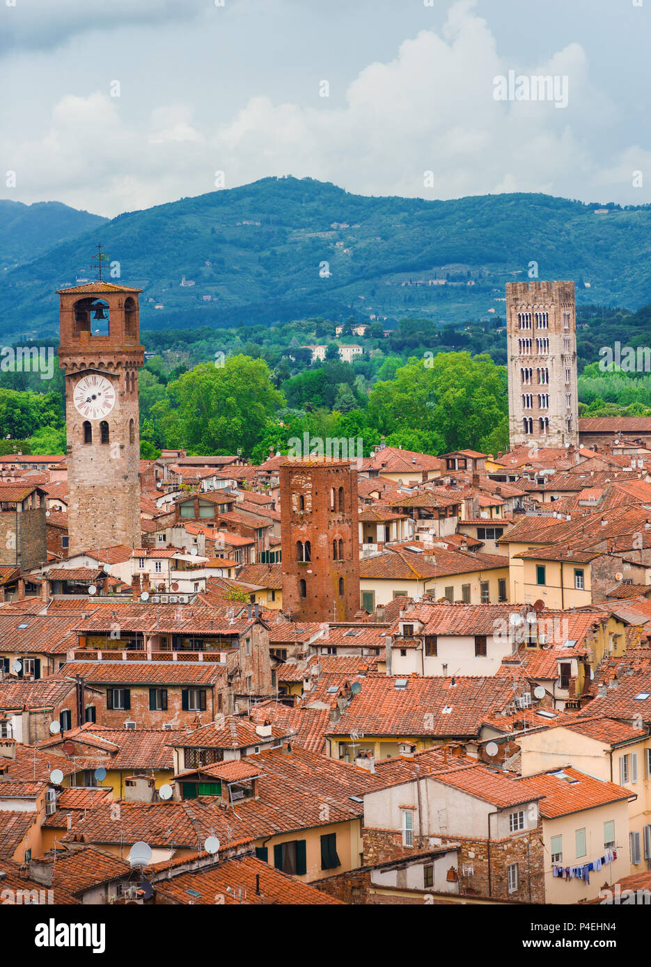 Lucca old historic center skyline with medieval towers and clouds above ...