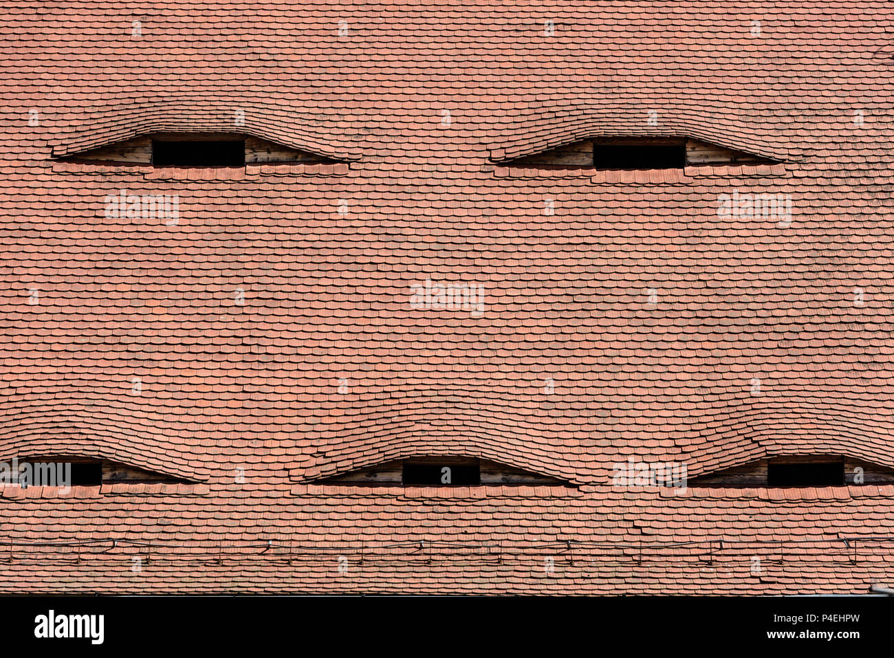 Roof with eye-like windows. Old windows at the top of the house Stock ...