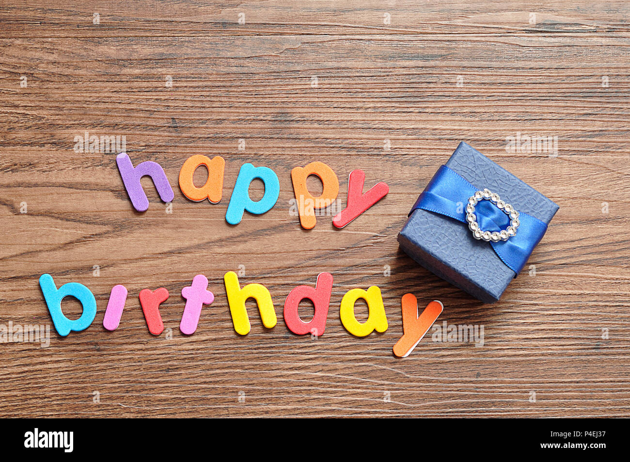 Happy birthday in colorful letters with a blue gift box Stock Photo - Alamy