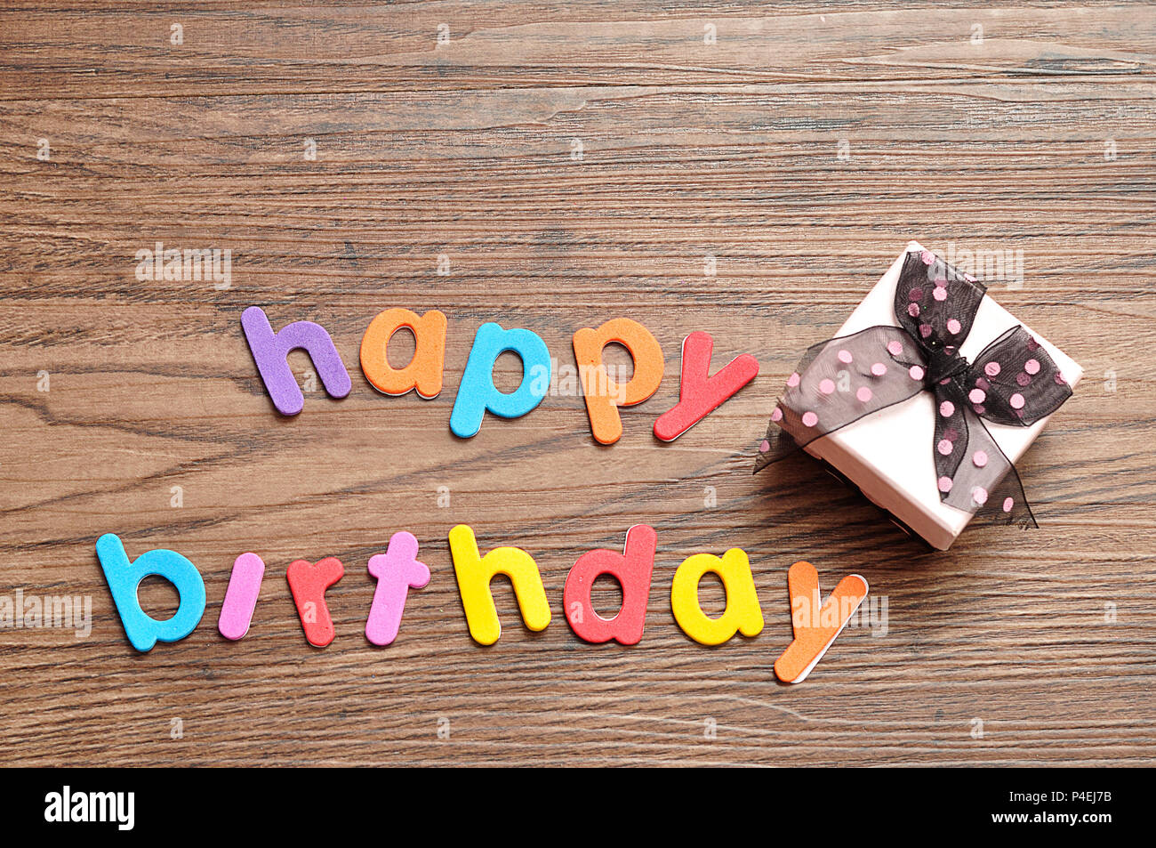 Happy birthday in colorful letters with a pink gift box Stock Photo - Alamy
