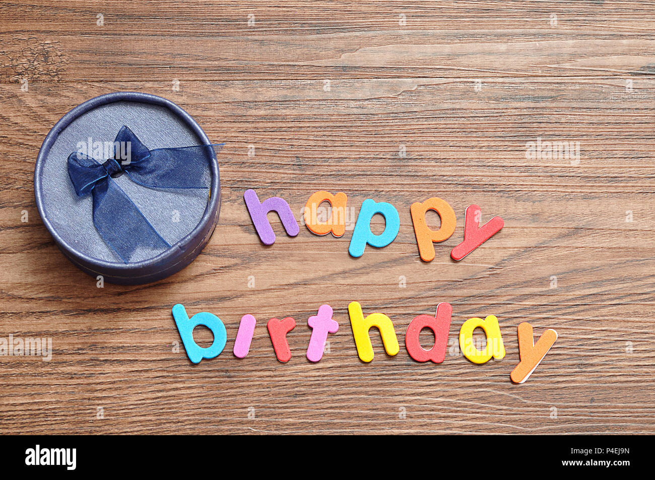 Happy birthday in colorful letters with a blue gift box Stock Photo - Alamy