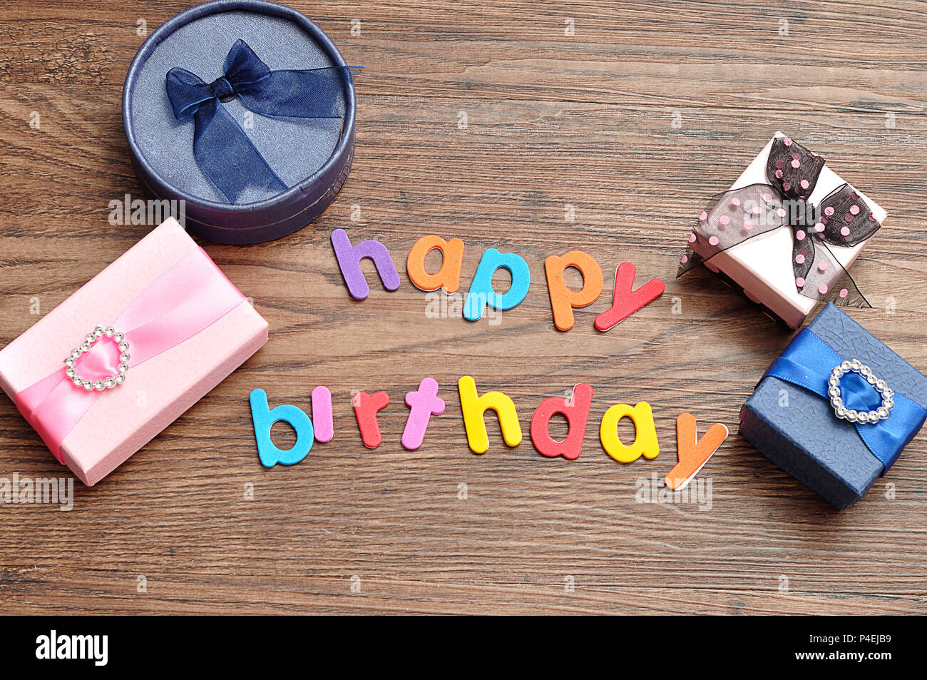 Happy birthday in colorful letters with a variety of gift boxes Stock ...