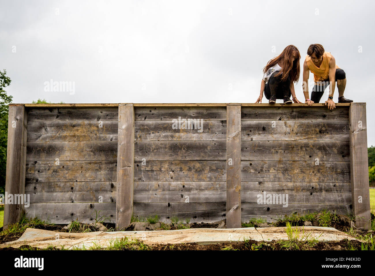 CAMP FUJI, SHIZUOKA, Japan- Participants look over the edge of a wall ...
