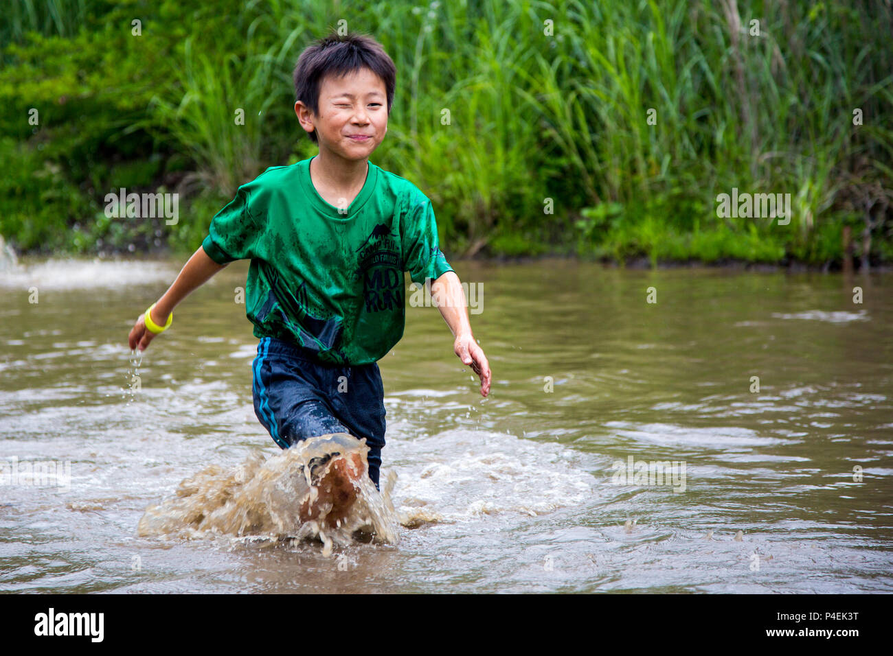 CAMP FUJI, SHIZUOKA, Japan- A child splashes through the kids’ course ...