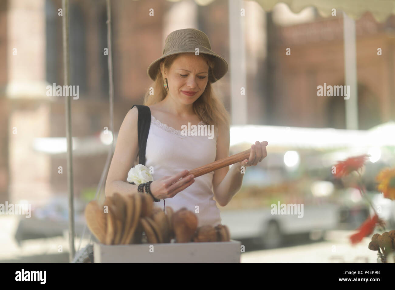 Woman looking at wooden spoons in a street market Stock Photo - Alamy