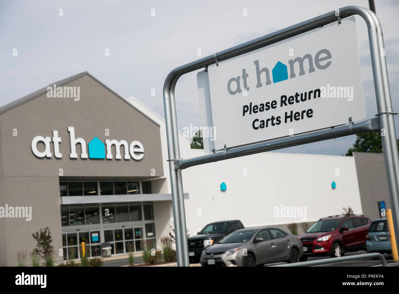 A logo sign outside of a At Home retail store in Fredericksburg ...