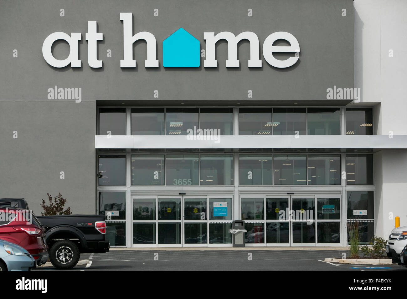 A logo sign outside of a At Home retail store in Fredericksburg ...