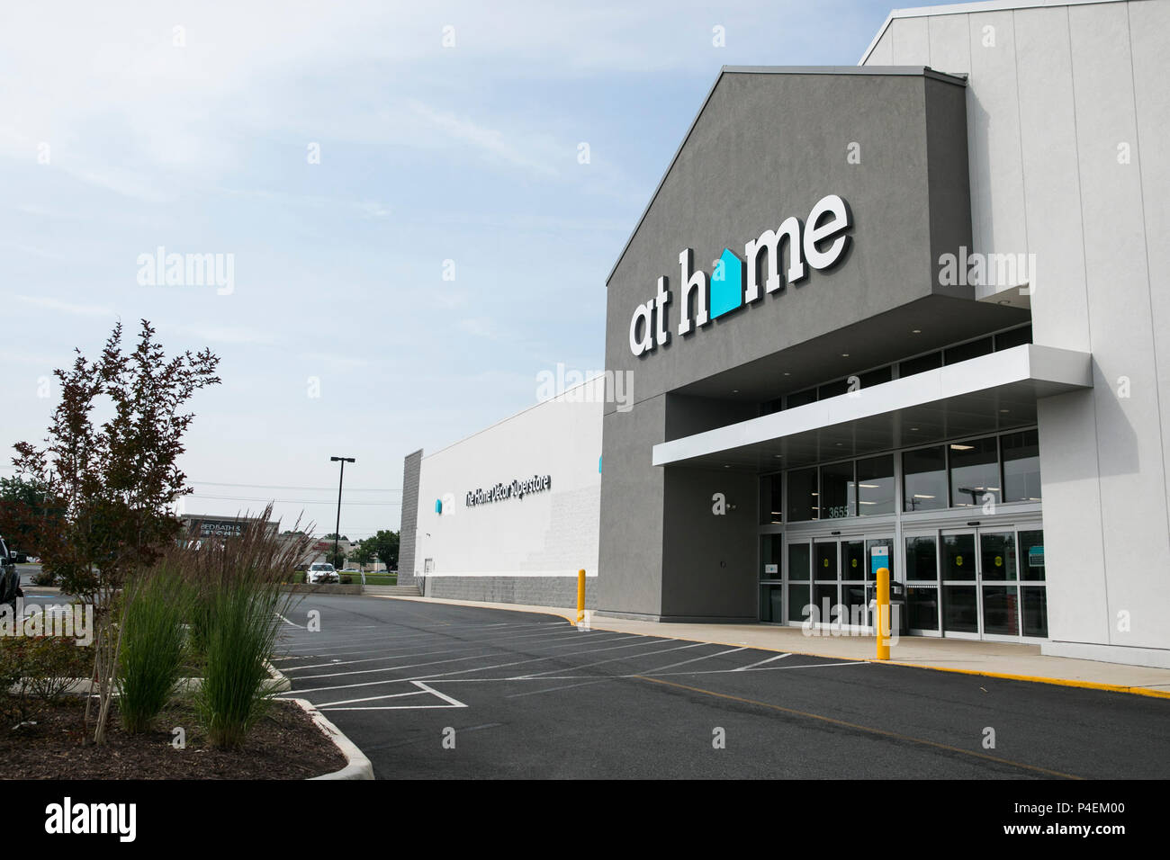A logo sign outside of a At Home retail store in Fredericksburg ...