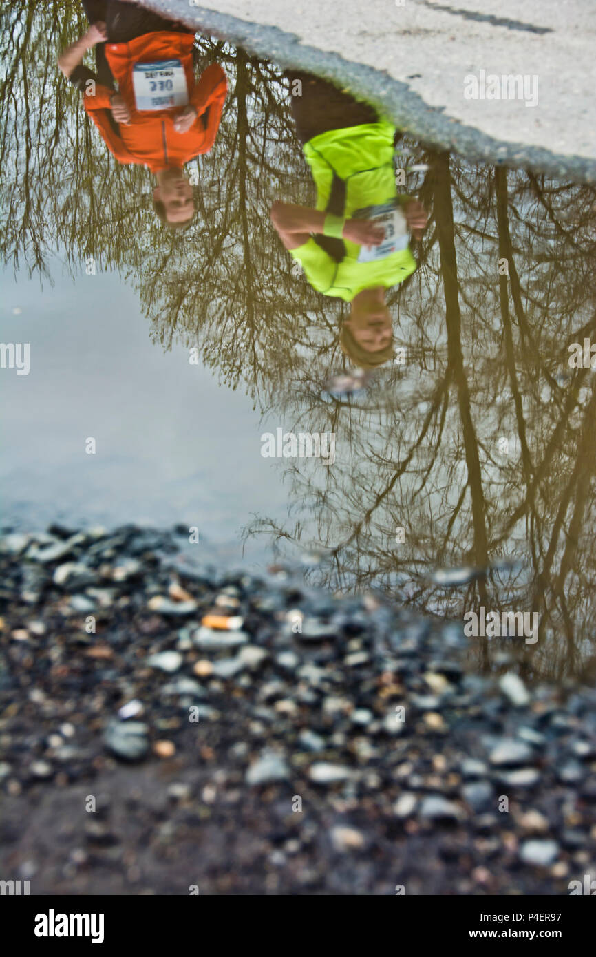 marathon runners reflected in a pool of water Stock Photo - Alamy
