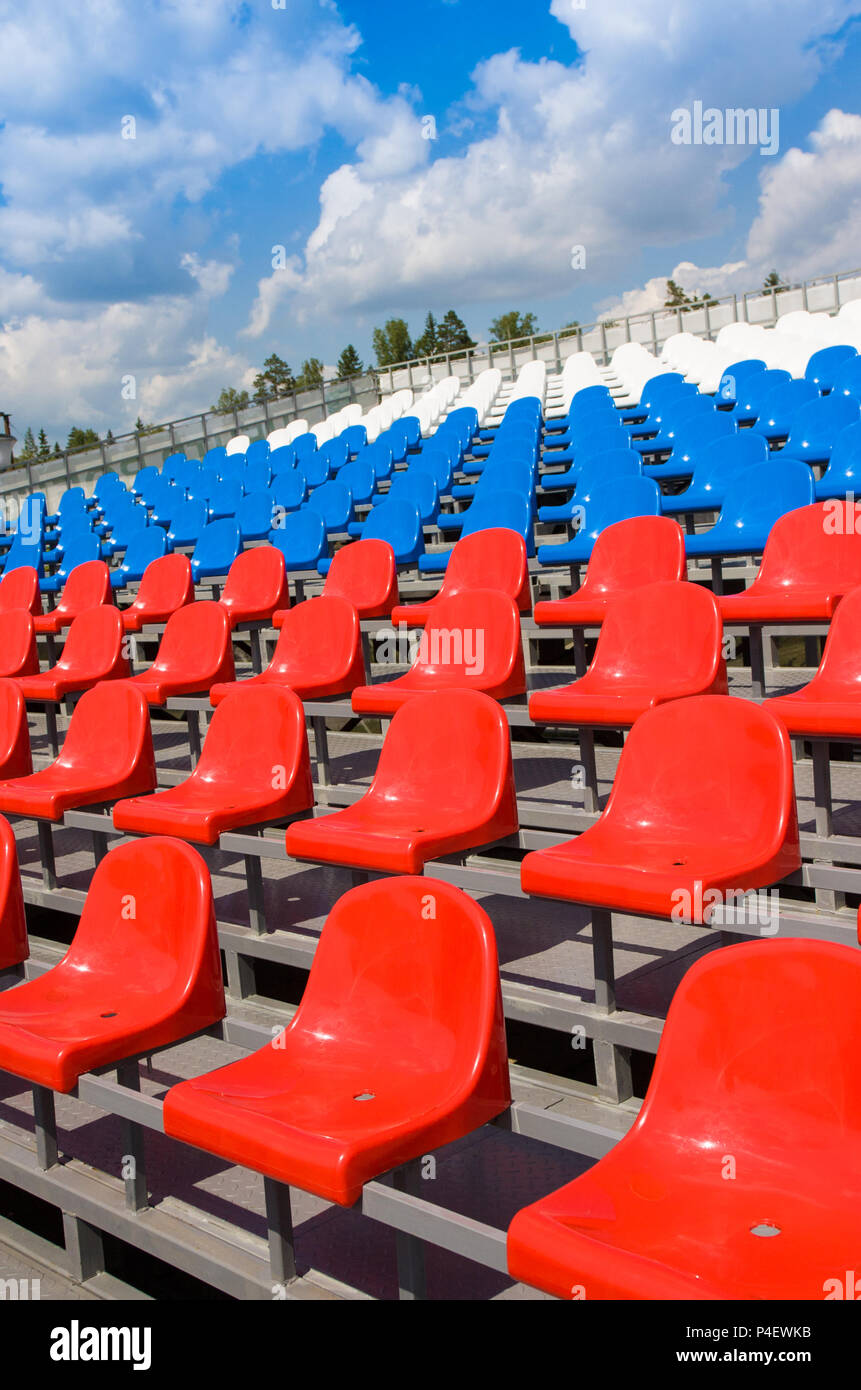 Plastic seats on stadium Stock Photo - Alamy
