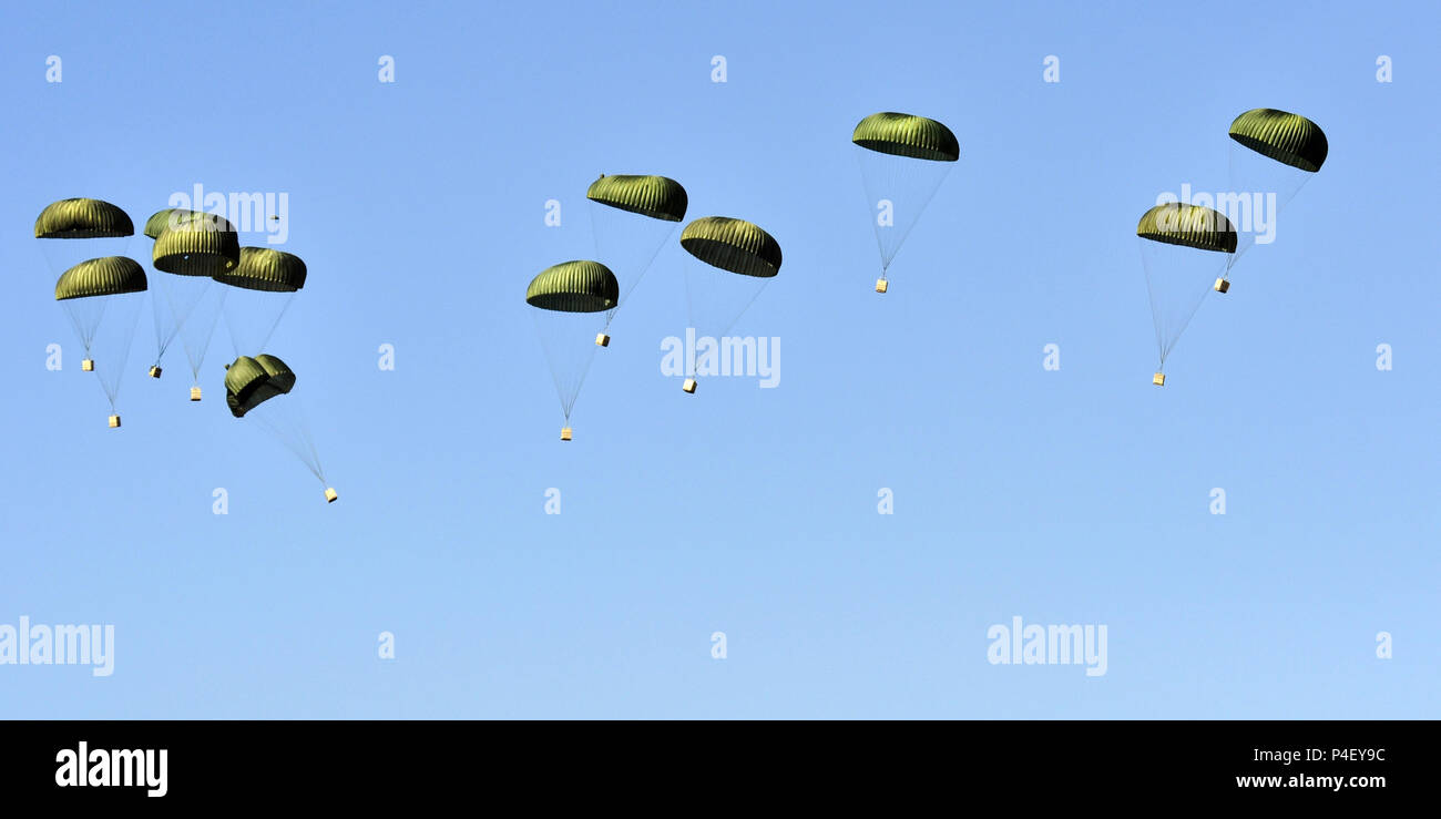 Military parachutes dropping emergency supplies Stock Photo - Alamy