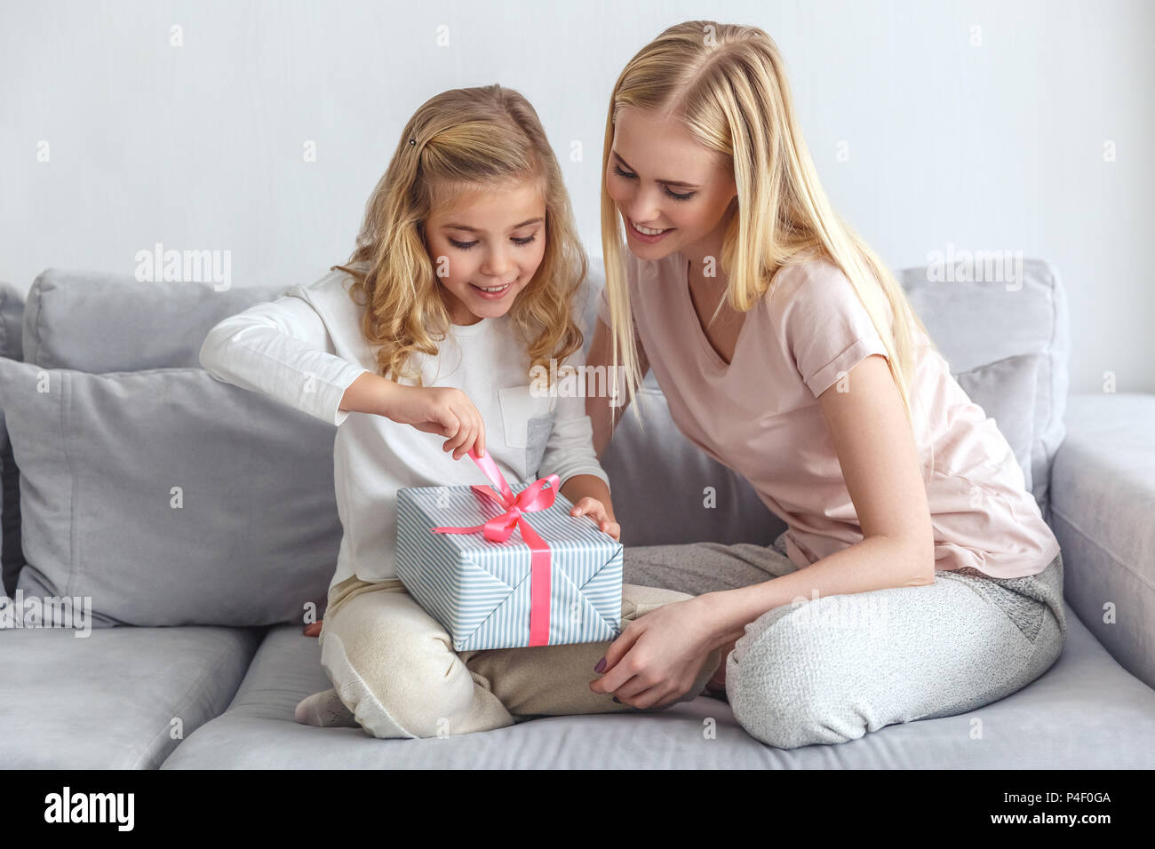 daughter opening birthday gift made by mother Stock Photo - Alamy