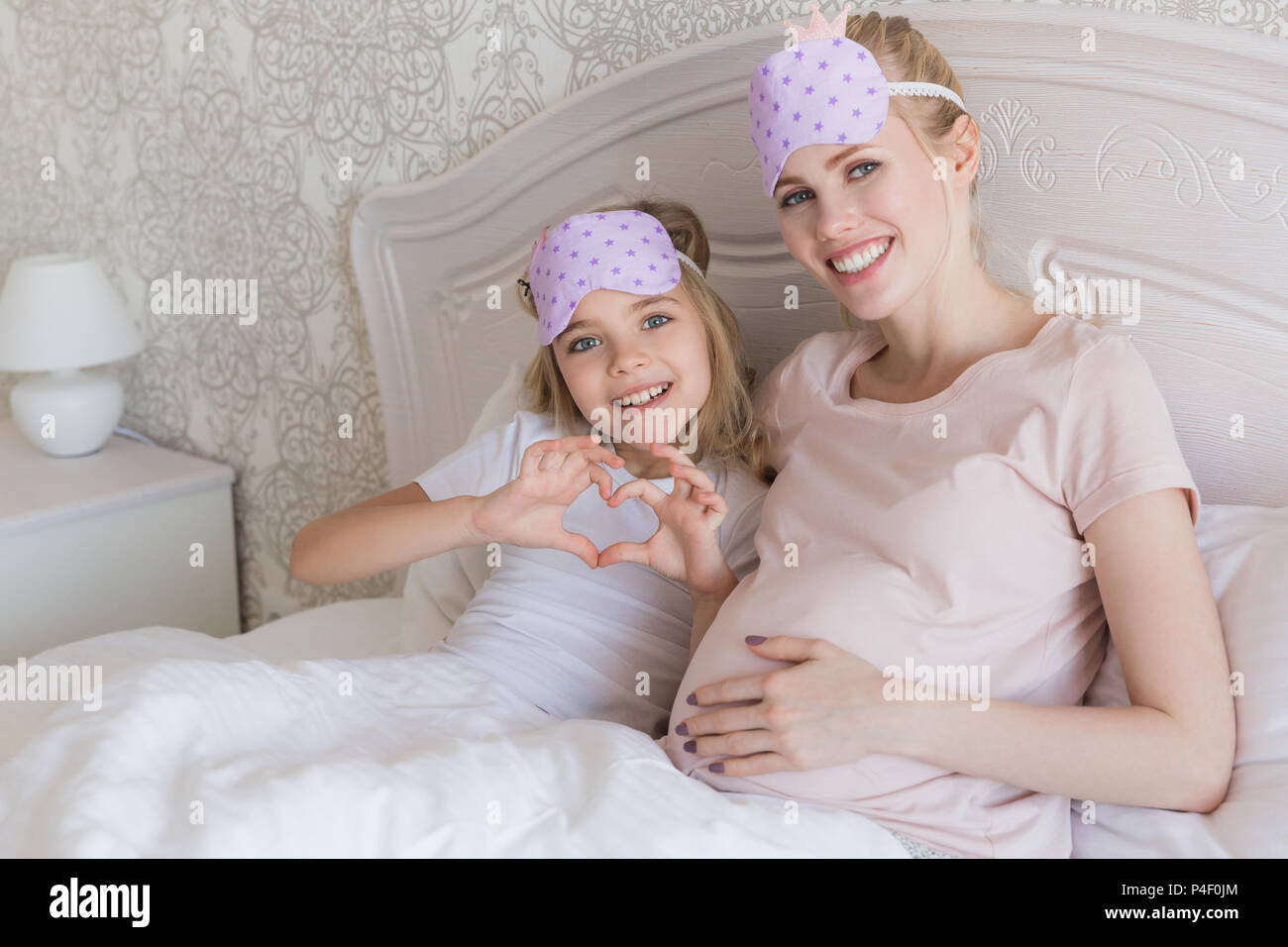 happy daughter showing heart with hands Stock Photo - Alamy