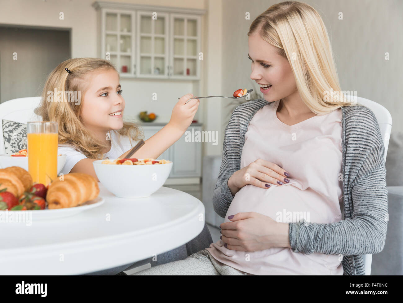 Smiling girl eating oatmeal hi-res stock photography and images - Alamy