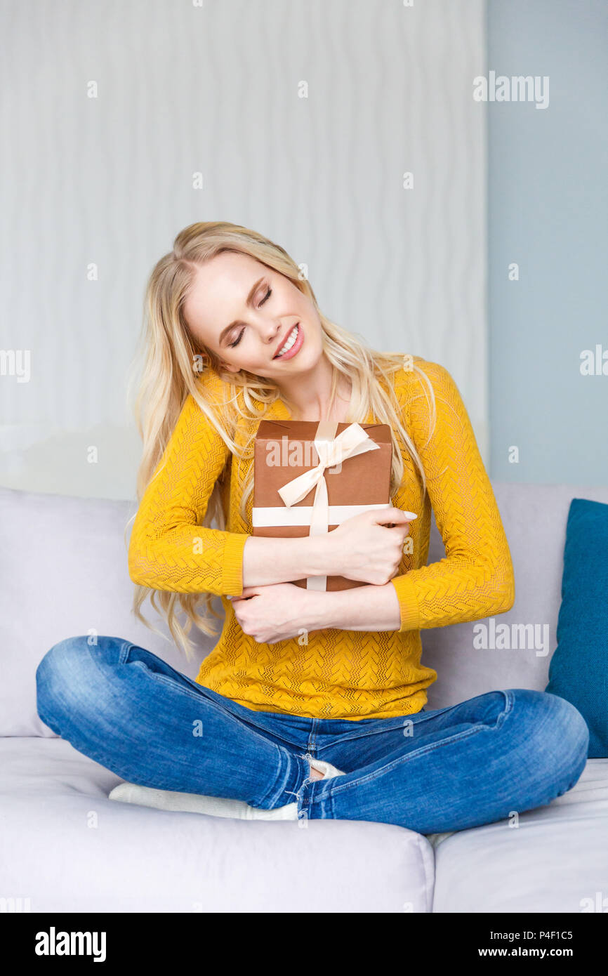 Young woman hugging gift box hi-res stock photography and images - Alamy