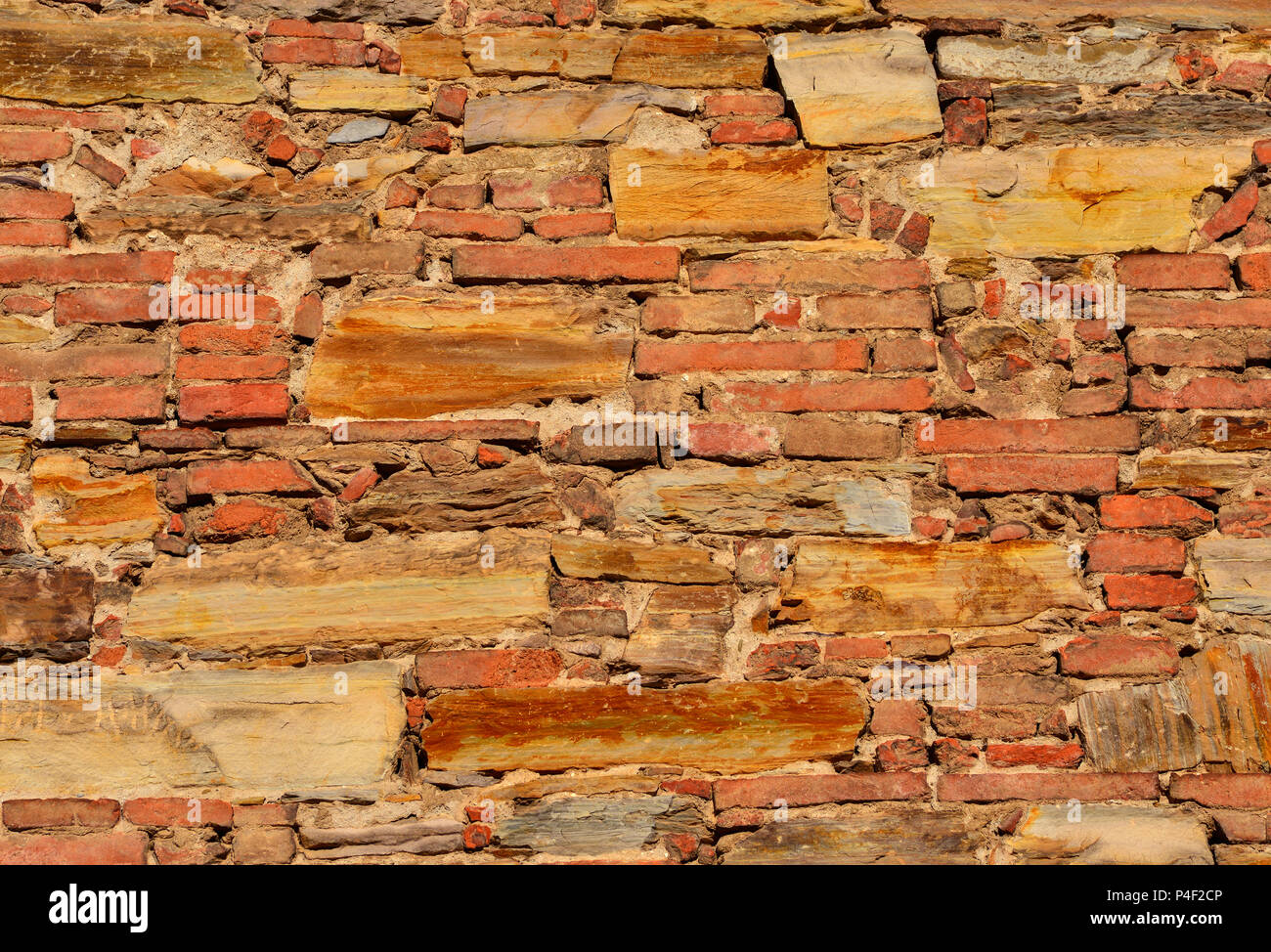 Old composite wall with stone blocks and bricks as background Stock ...