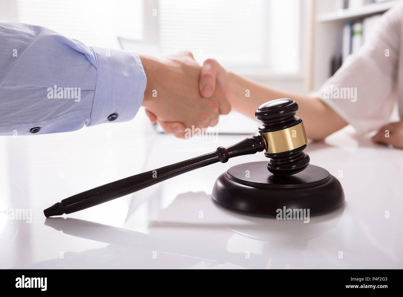 Close-up Of Mallet In Front Of Judge Shaking Hands With His Client ...