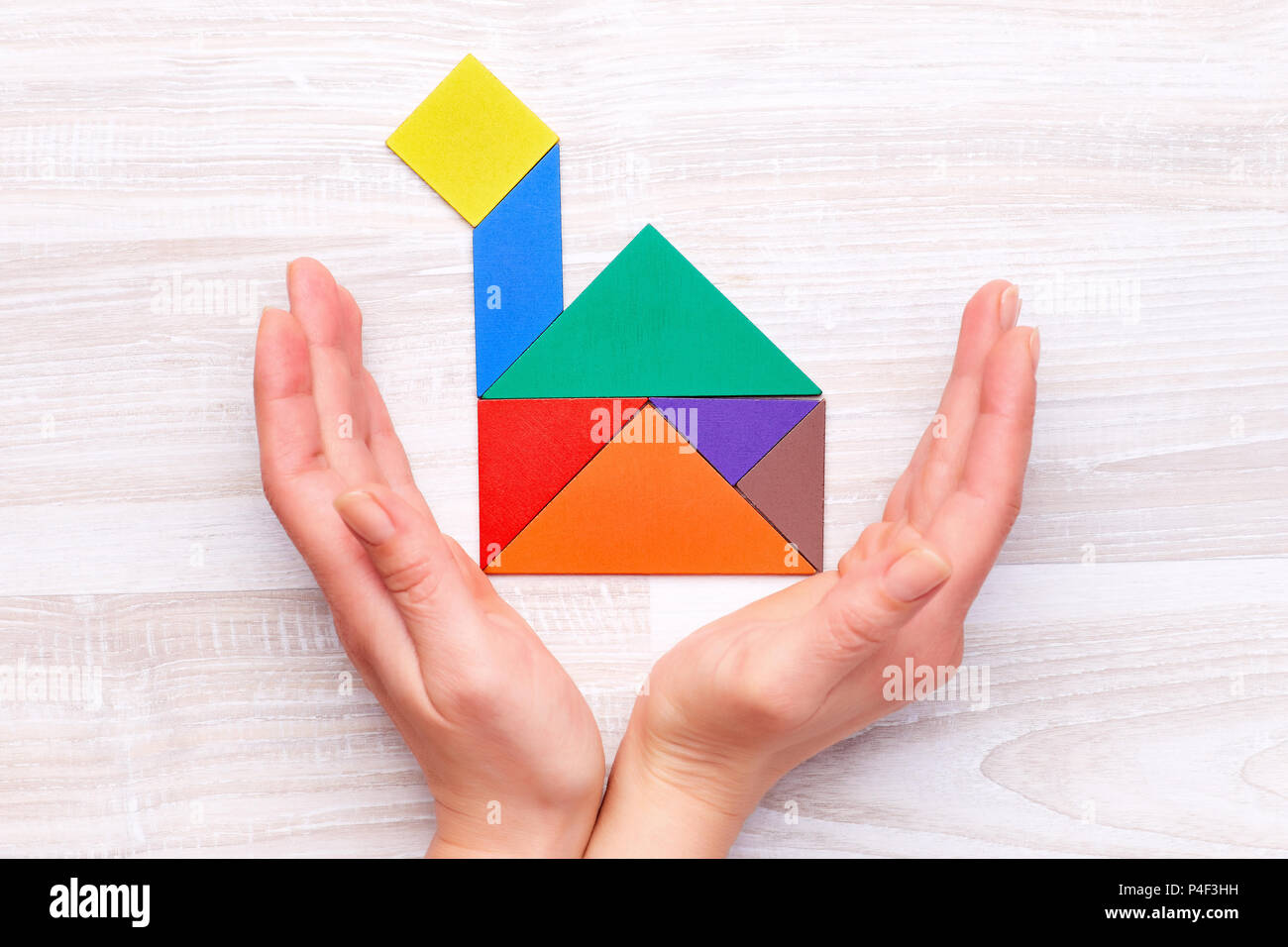 From above shot of hands person protect tangram figures into shape of ...