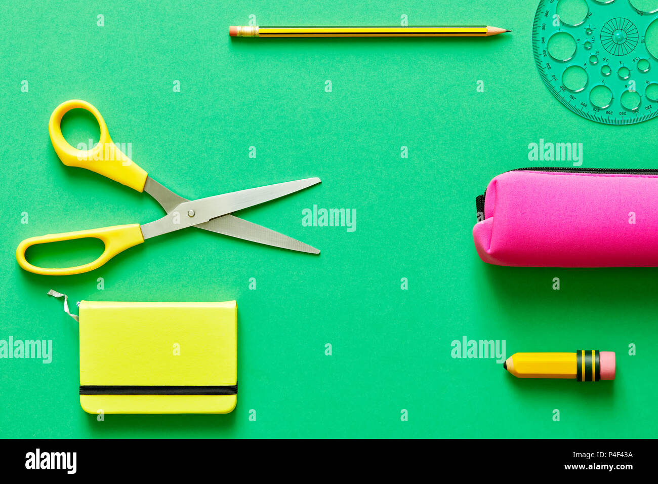 School tools such as yellow scissors, pencil, ruler, eraser, and pencil ...