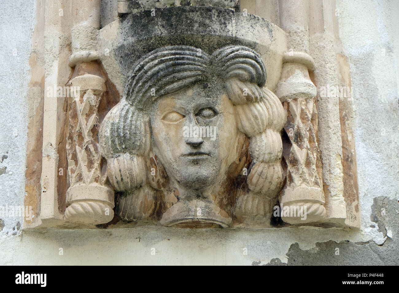 Architectural detail with a mascaron of a woman on the facade of an old ...